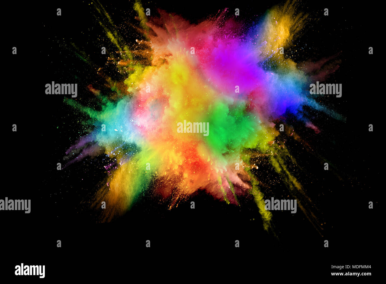 Multi color powder explosion isolated on black background. Colored dust ...