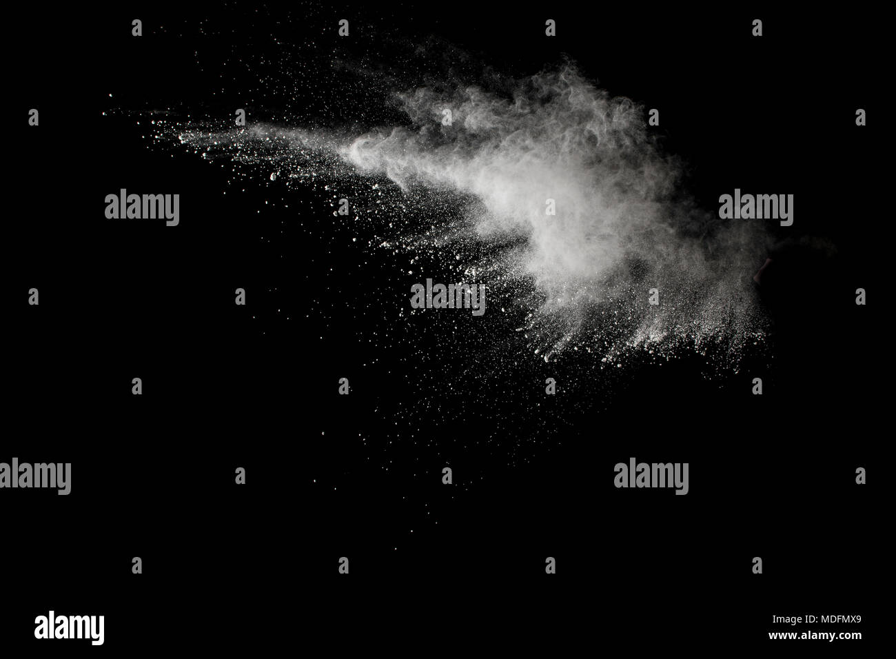 Bizarre forms of white powder explosion cloud against dark background ...