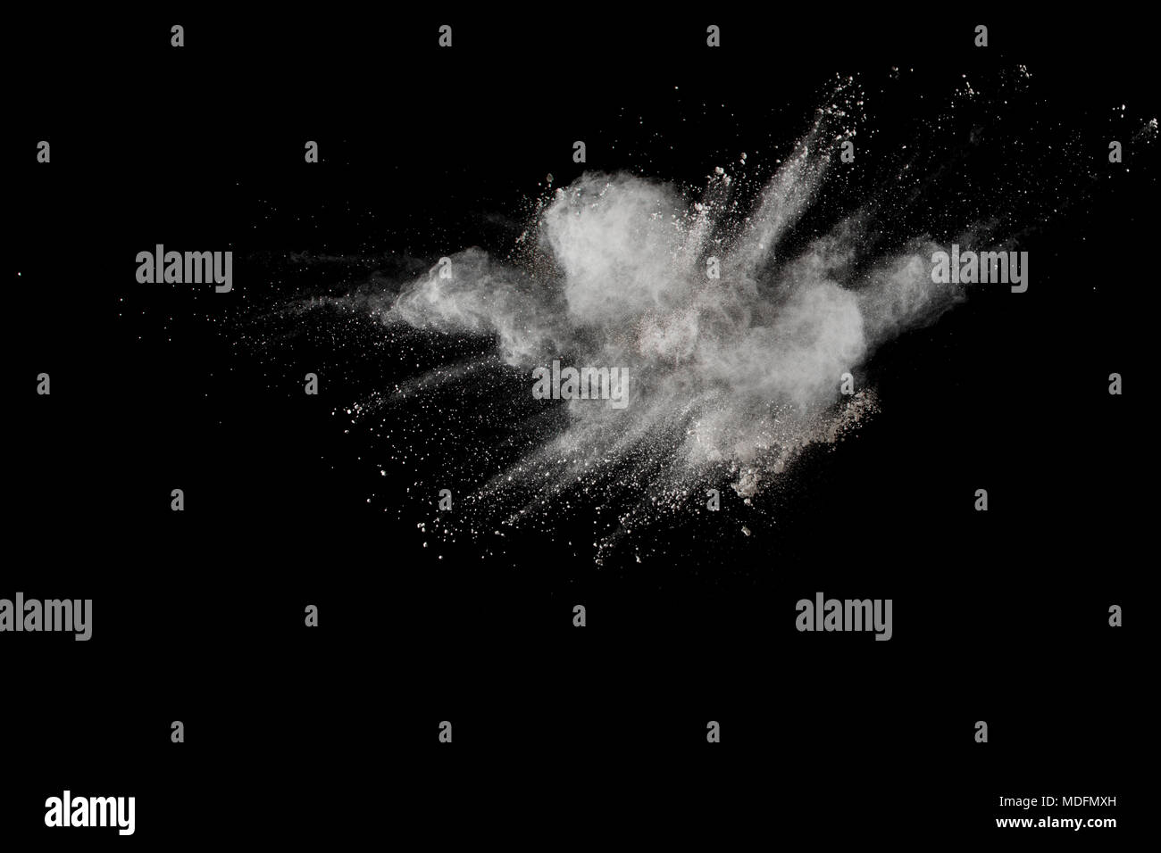 Bizarre forms of white powder explosion cloud against dark background ...