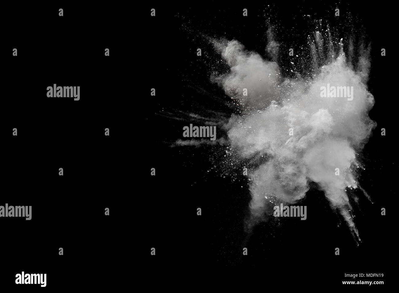 Bizarre forms of white powder explosion cloud against dark background ...