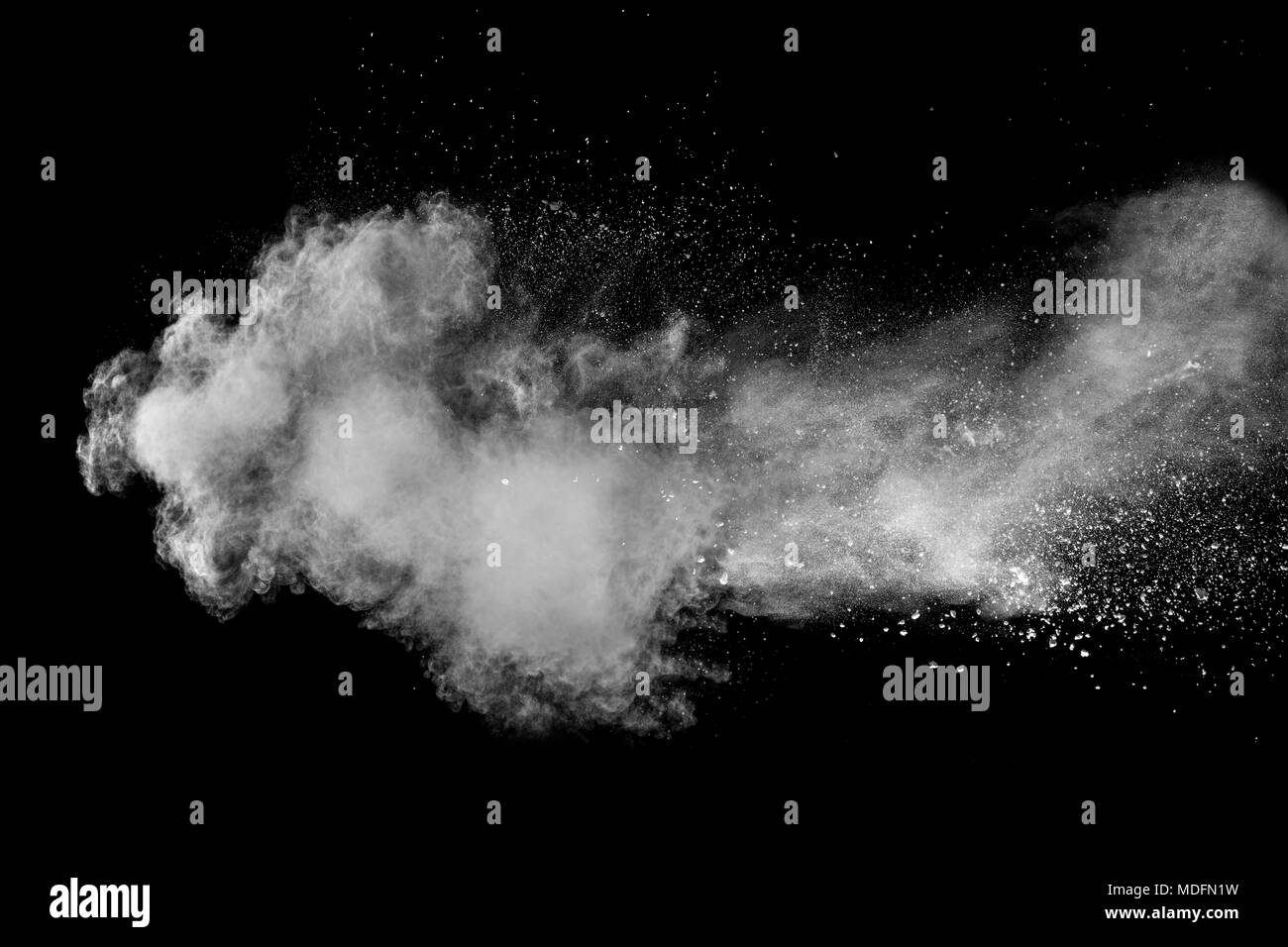 Bizarre forms of white powder explosion cloud against dark background ...