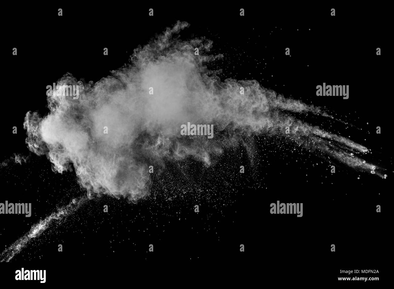 Bizarre forms of white powder explosion cloud against dark background ...