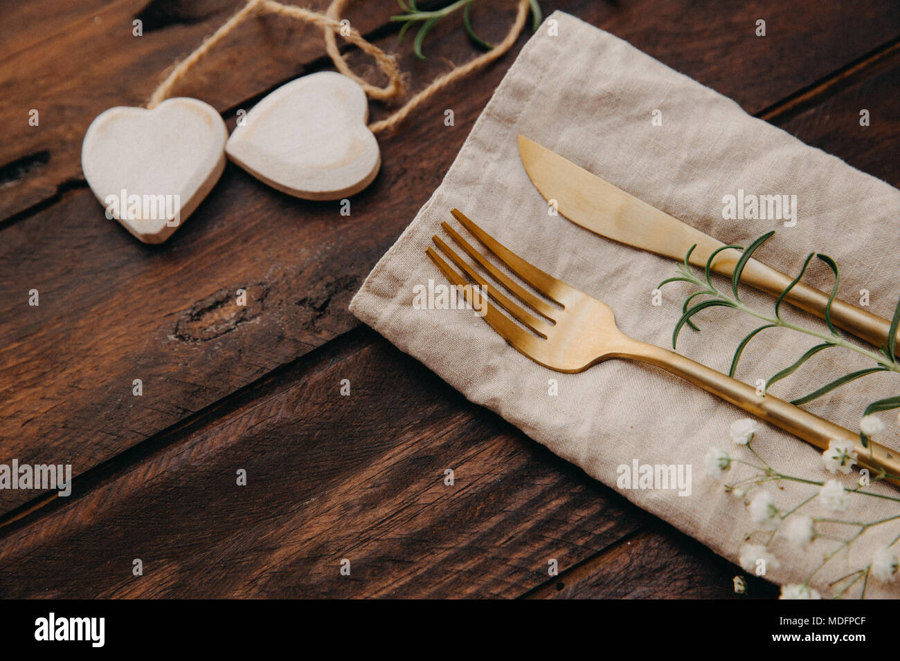 Gold cutlery and heart shape decorations Stock Photo - Alamy