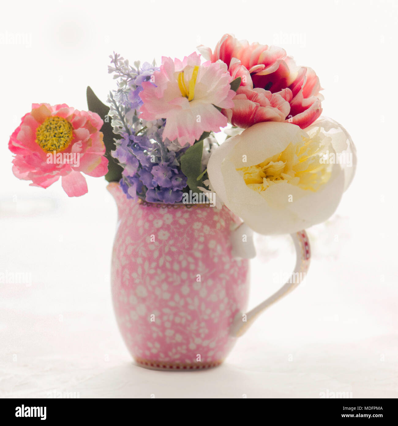 Flowers in a pink pitcher Stock Photo - Alamy