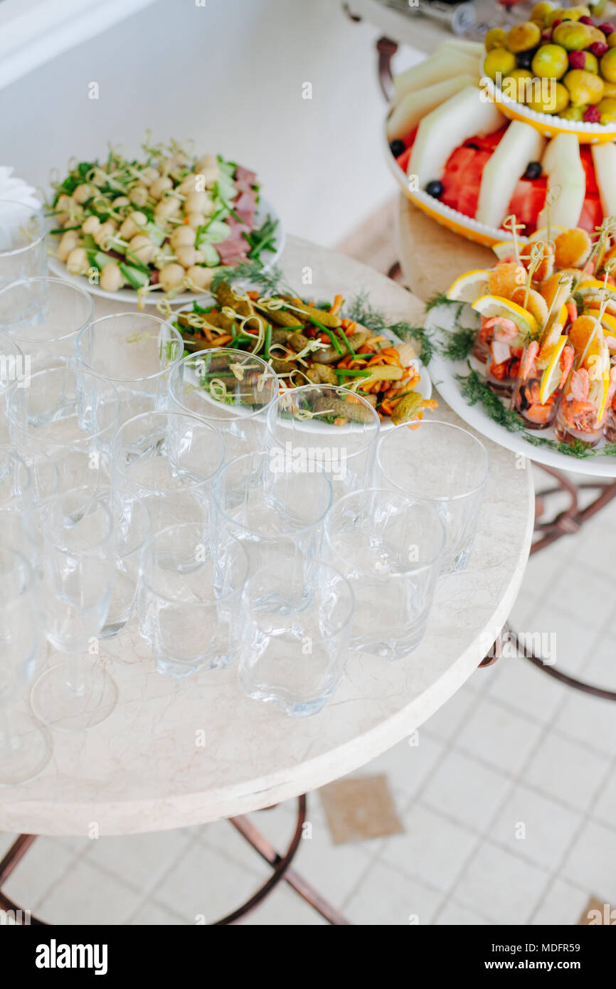 Table with buffet food and glasses Stock Photo - Alamy