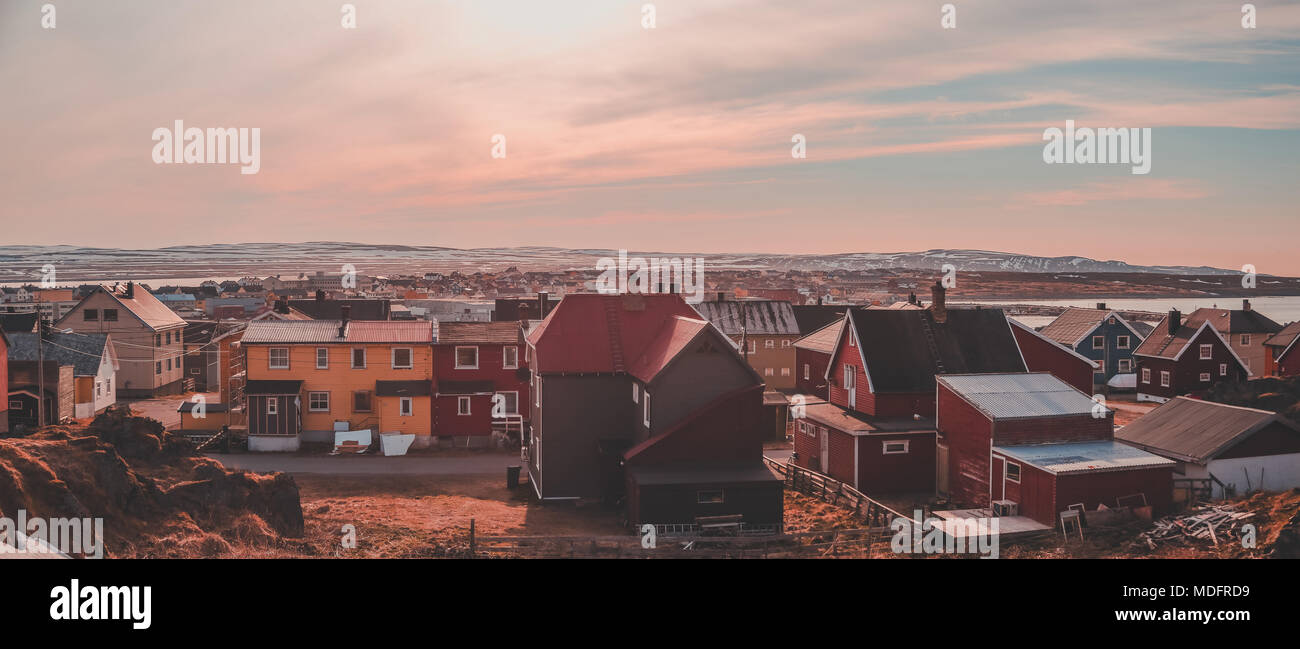 Norway. View of Vardo city with houses and mountains with snow in the ...