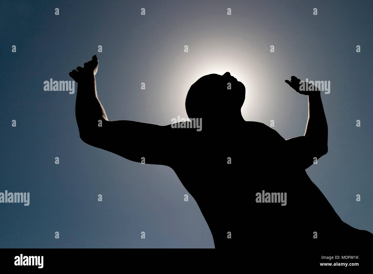 Silhouette young man raising arms hi-res stock photography and images ...
