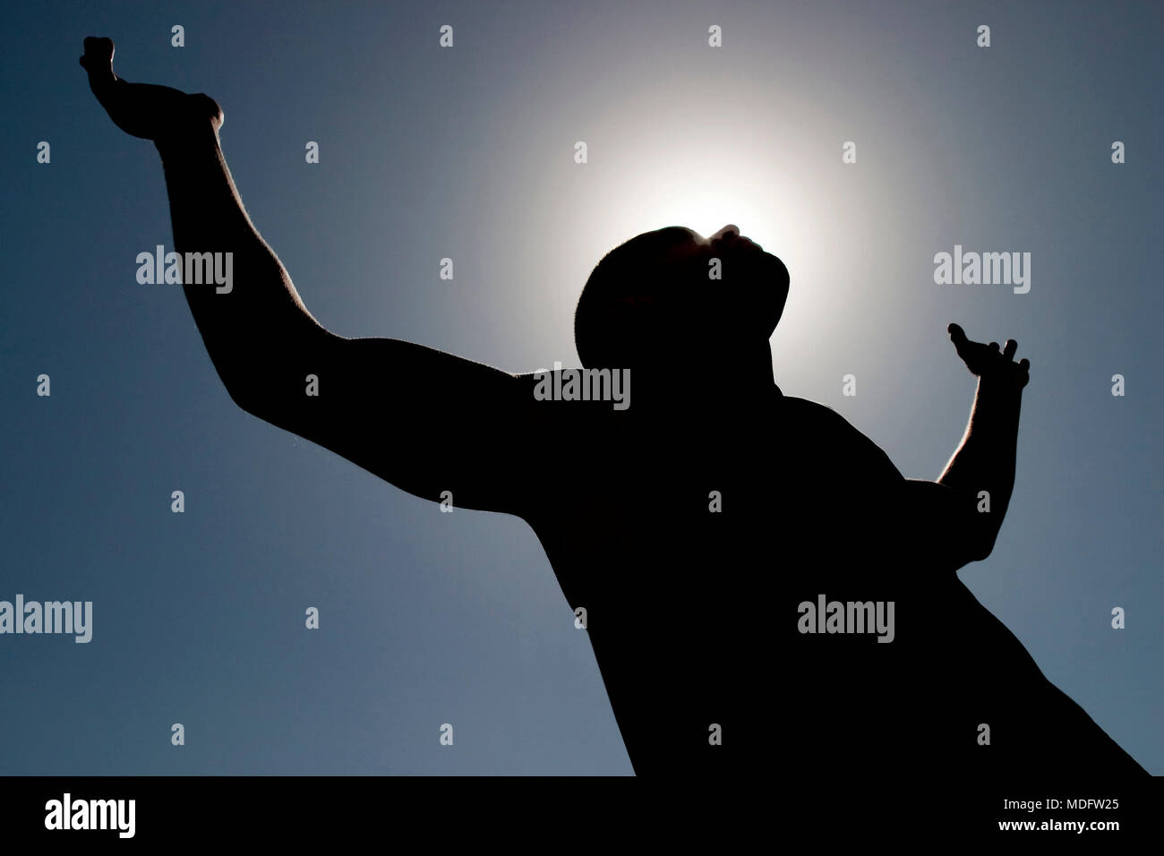 Silhouette young man raising arms hi-res stock photography and images ...