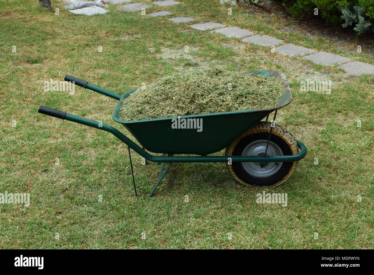 Grass wheelbarrow hi-res stock photography and images - Alamy