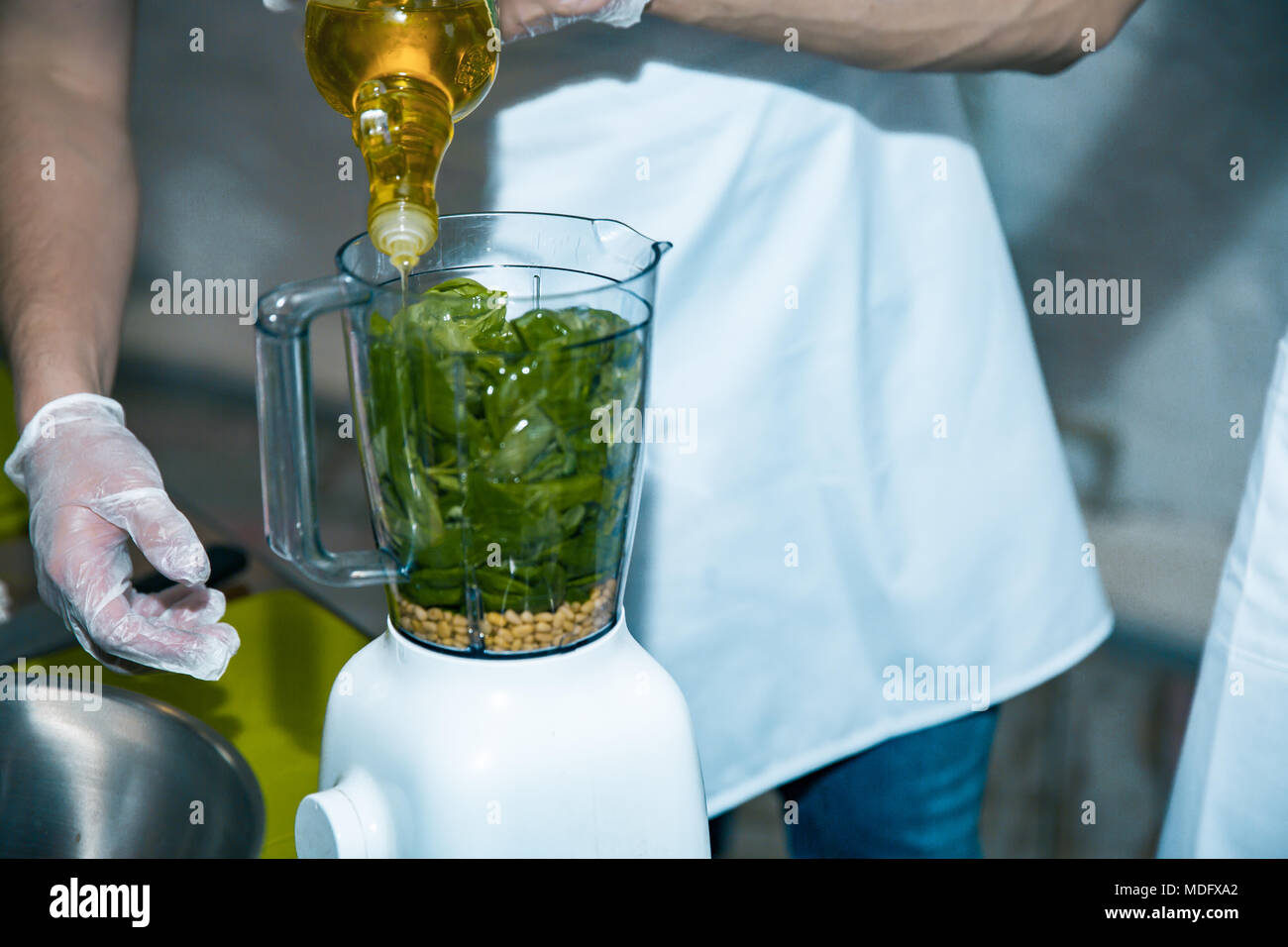 Vegetable smoothie chef blending green smoothies with blender home in ...