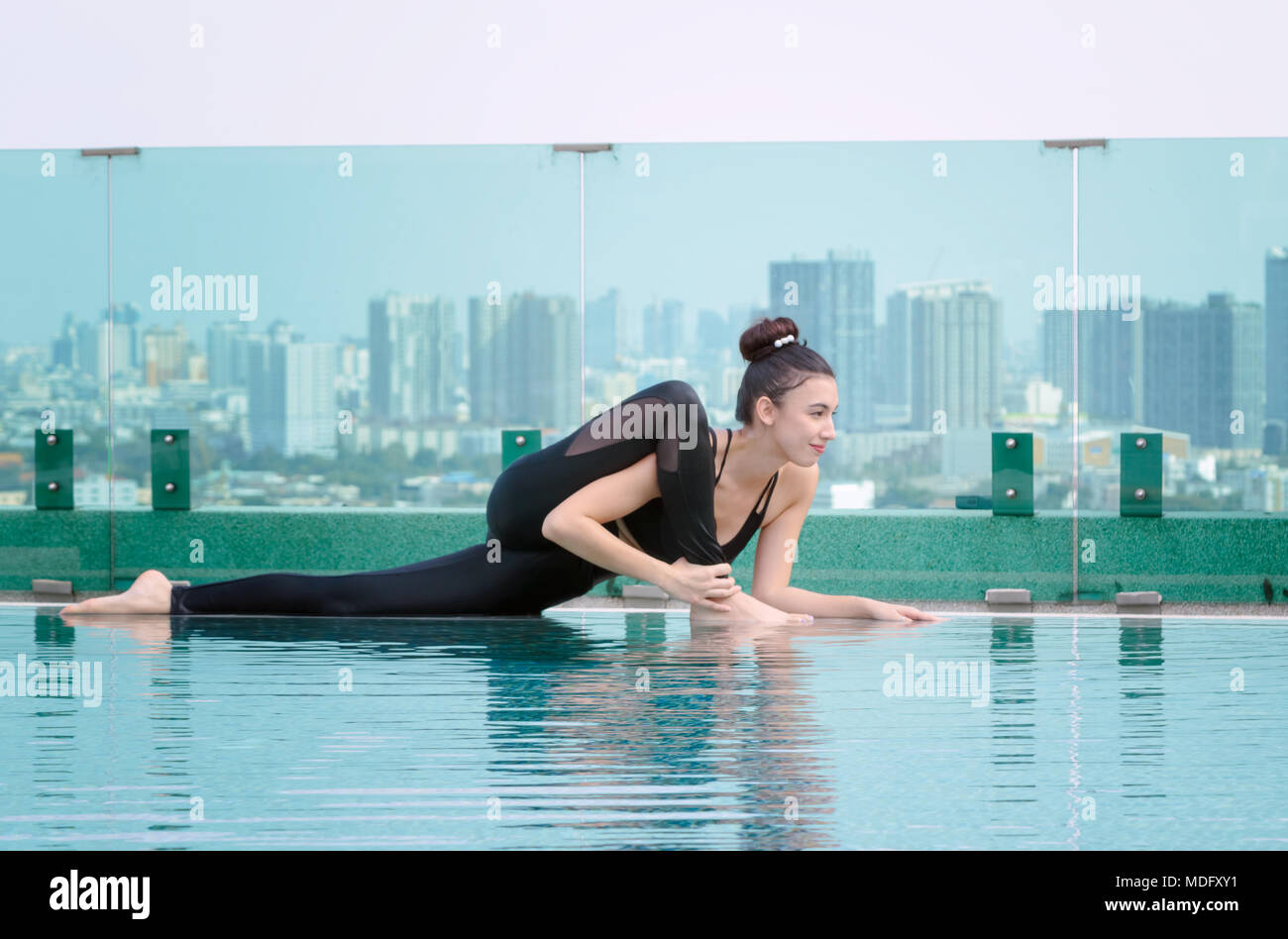 young women doing yoga pose at the swimming pool Stock Photo - Alamy