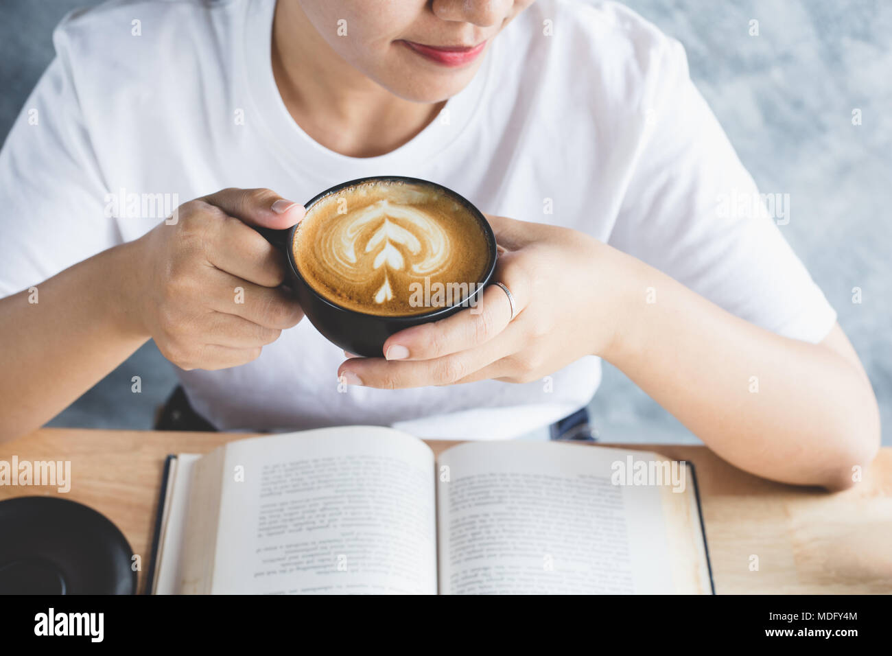 Girl in cafe reading book hi-res stock photography and images - Alamy