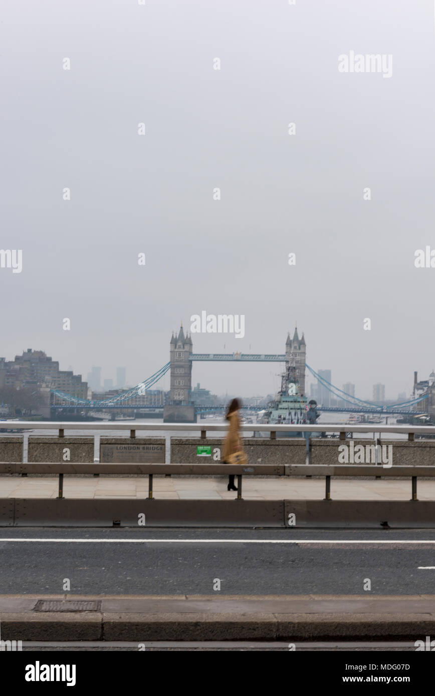 Woman walking across london bridge hi-res stock photography and images ...
