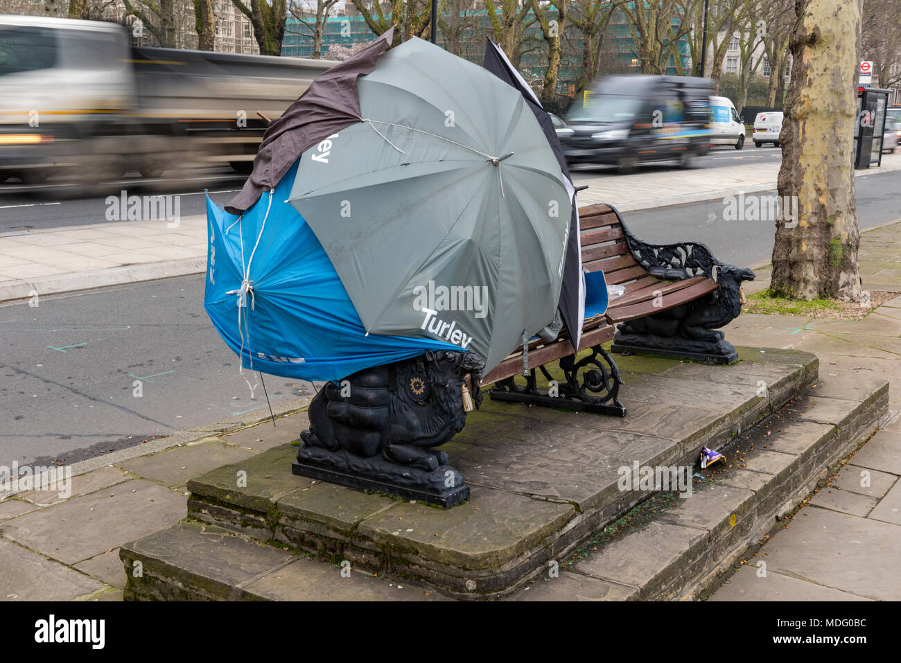 a makeshift shelter for a homeless person on a bench on the north bank ...