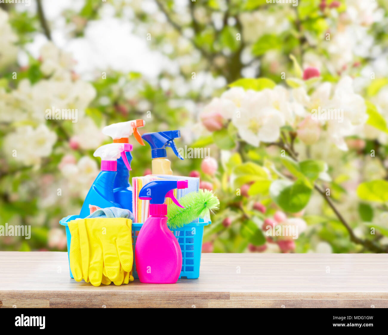 Spring cleaning concept - colorful sprays bottles and rubbers on wood ...