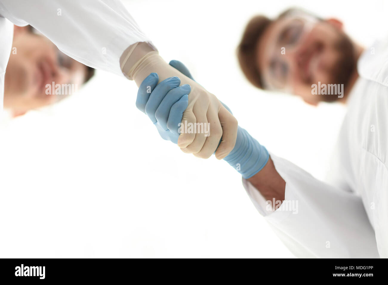 closeup.two scientists shake hands Stock Photo - Alamy
