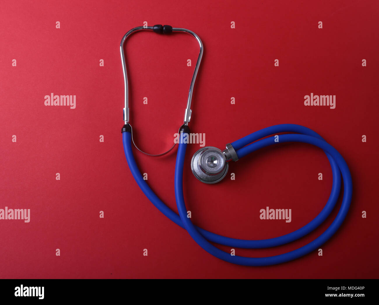 Medical blue stethoscope isolated on red background Stock Photo - Alamy