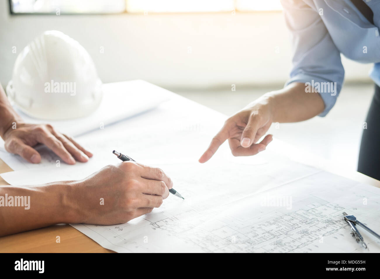 Close-up Of Person's engineer Hand Drawing Plan On Blue Print with ...