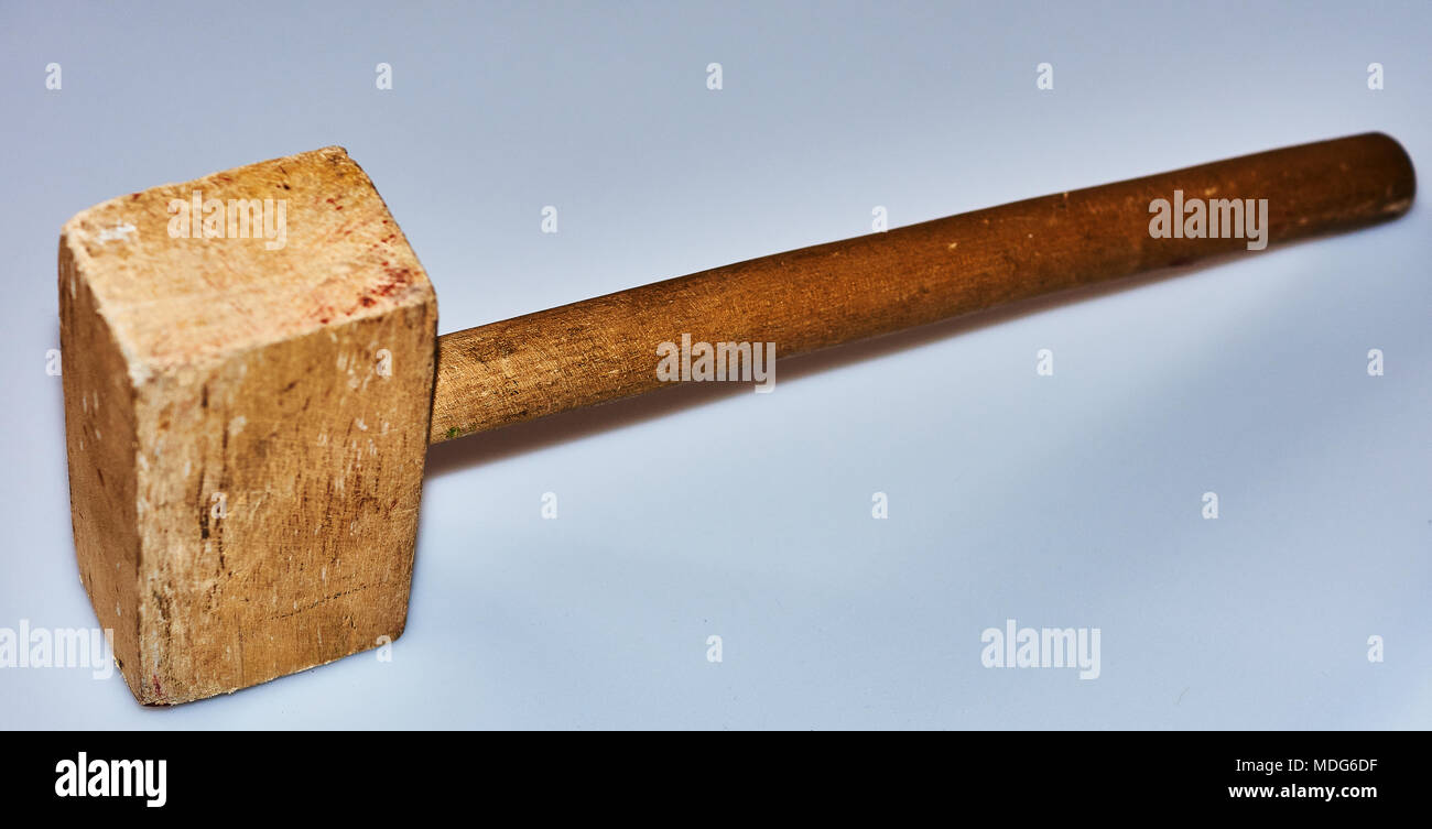 A hammer from a tree lies on an isolated background. The hammer was ...