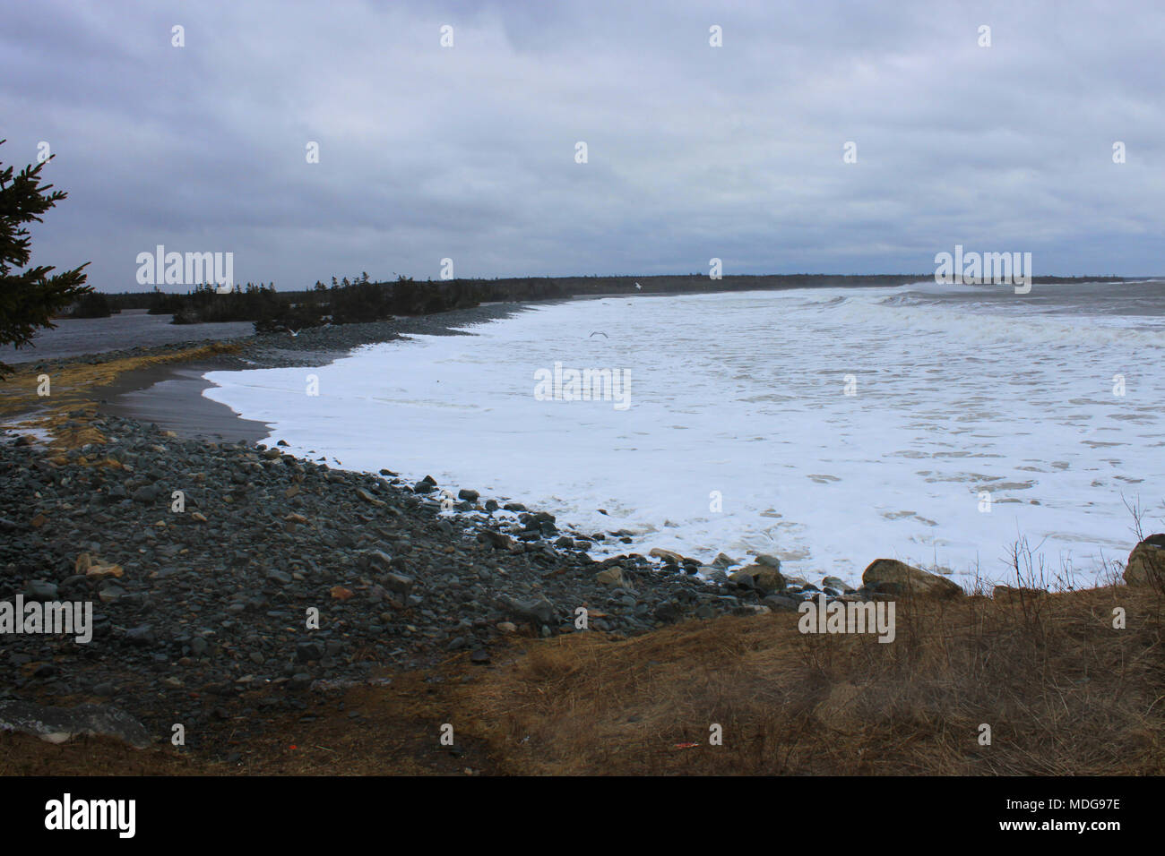 Waves breaching barrier and spilling into Big Lake at Long Beach, Lower ...