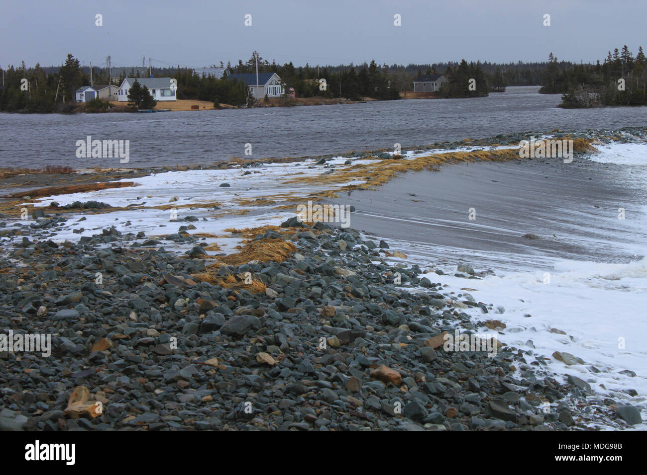 Waves breaching barrier and spilling into Big Lake at Long Beach, Lower ...