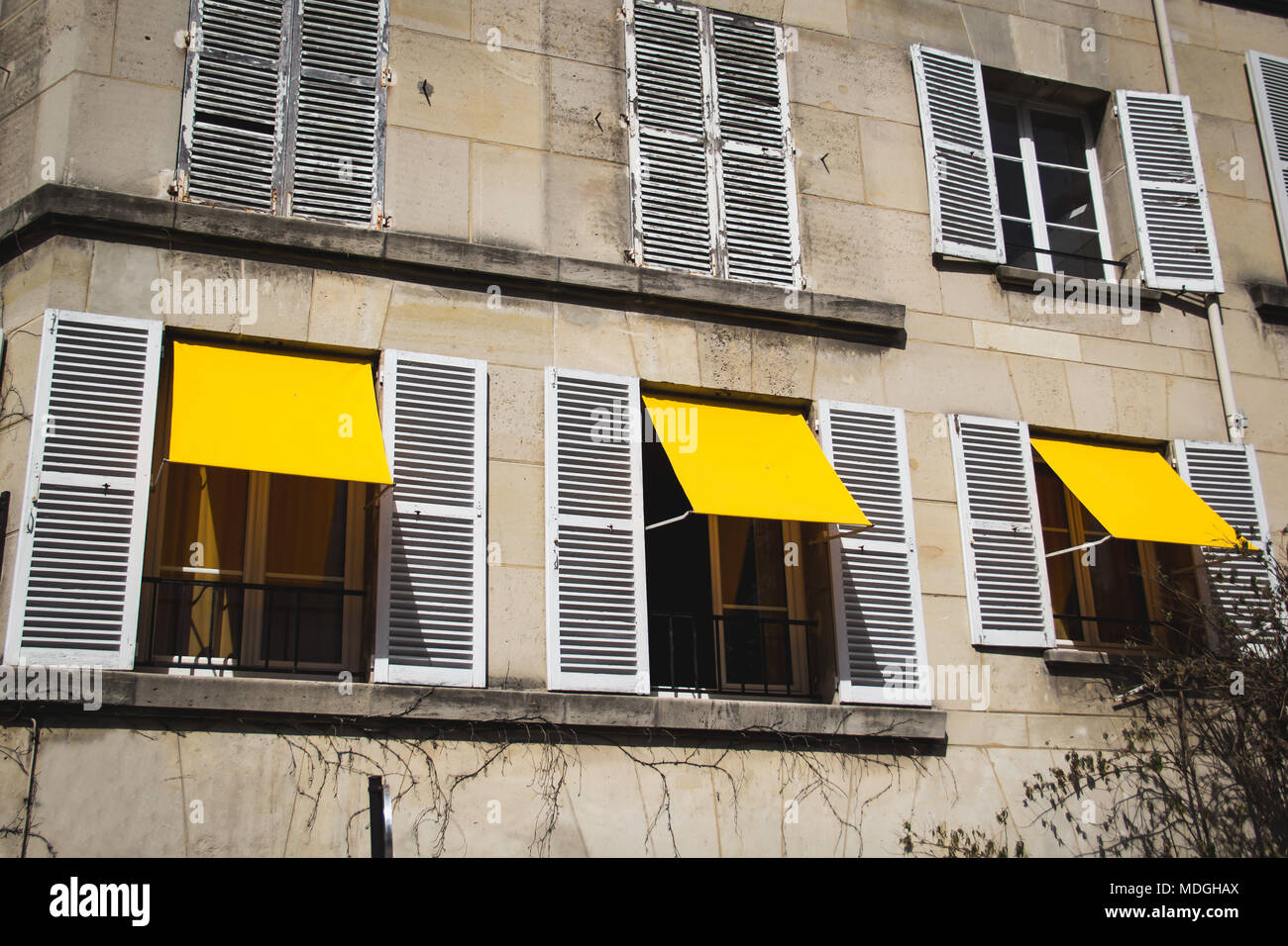 Three yellow window shutters on an apartment in Paris France Stock ...