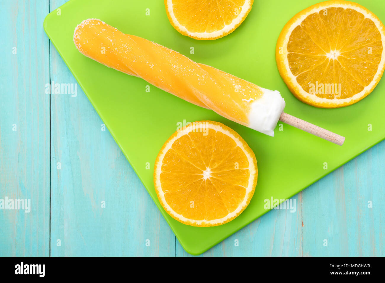 Orange popsicle on green board with fresh orange fruits Stock Photo - Alamy