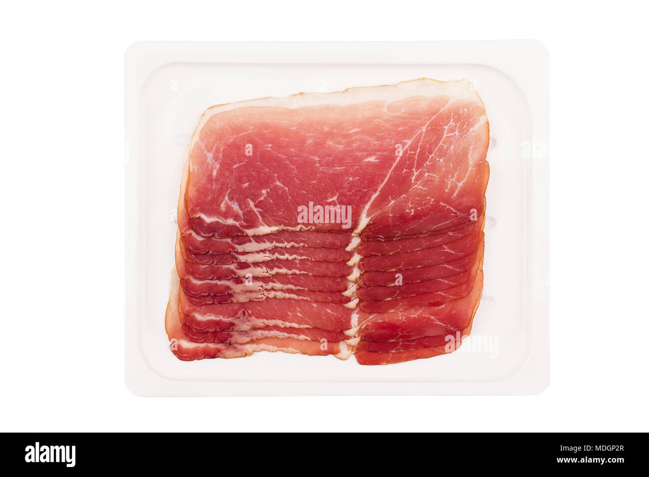 top view of slices of smoked pork loin ham in transparent plastic ...