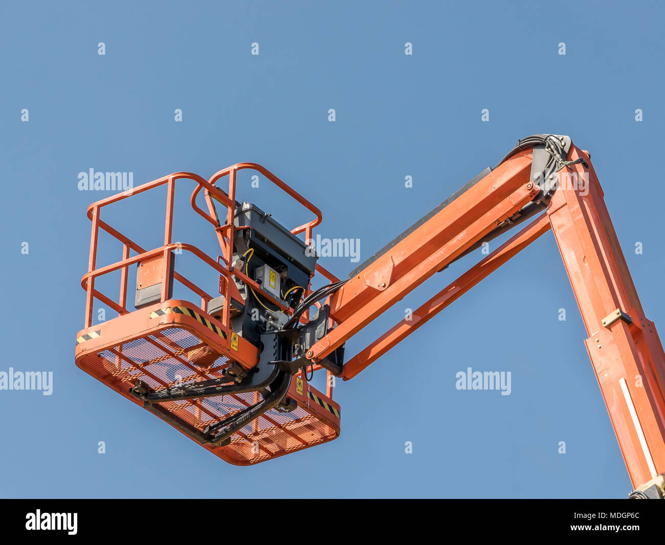 Single Orange Cherry Picker machinery against a blue sky Stock Photo ...