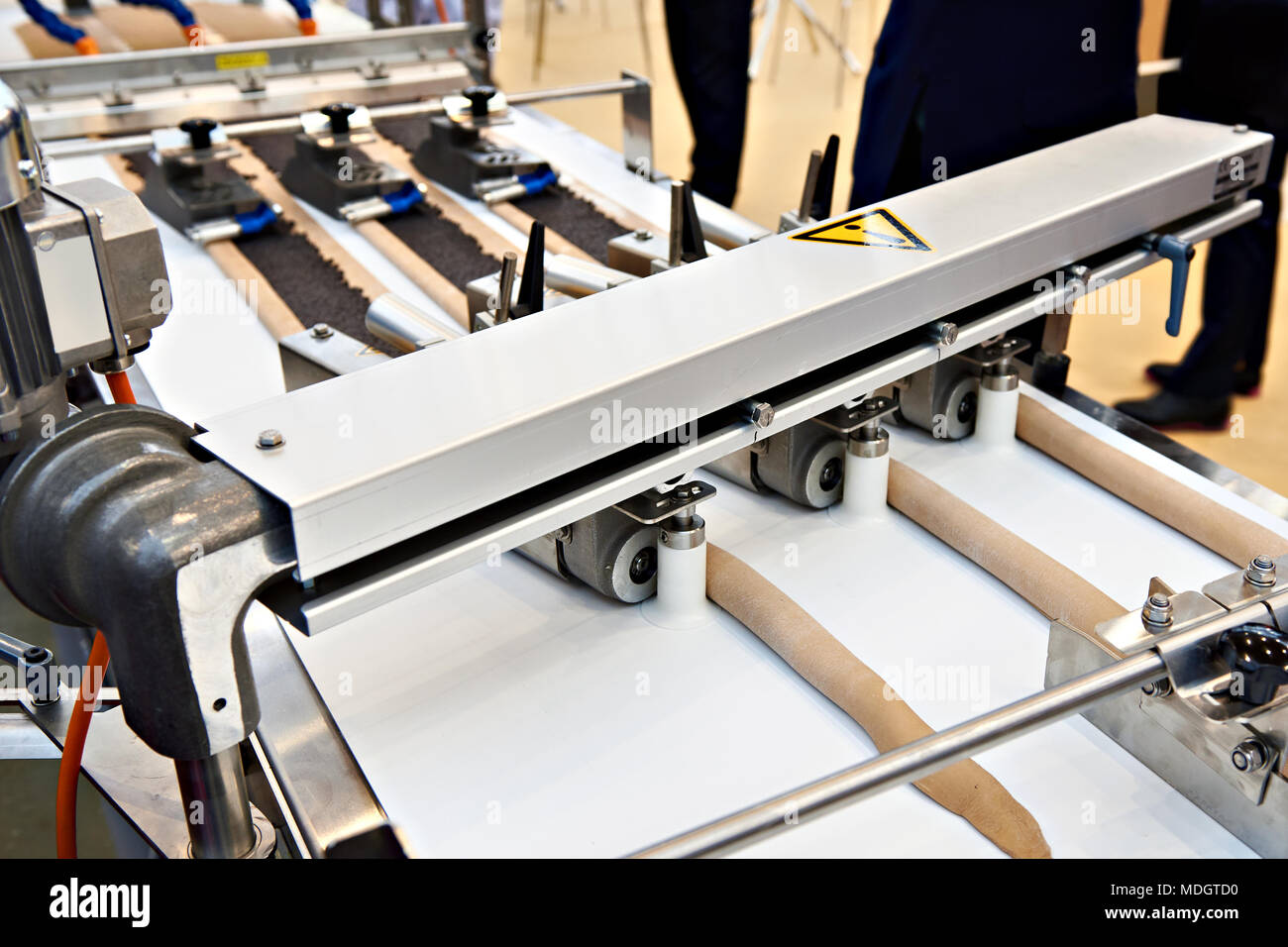 Machine with rollers for dough filling closeup Stock Photo - Alamy