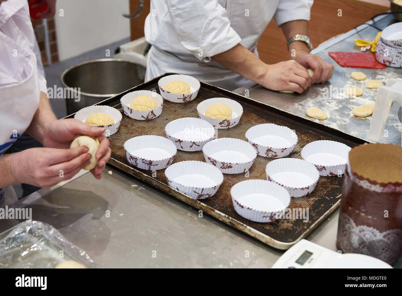 Bakers making buns in paper molds for baking Stock Photo - Alamy
