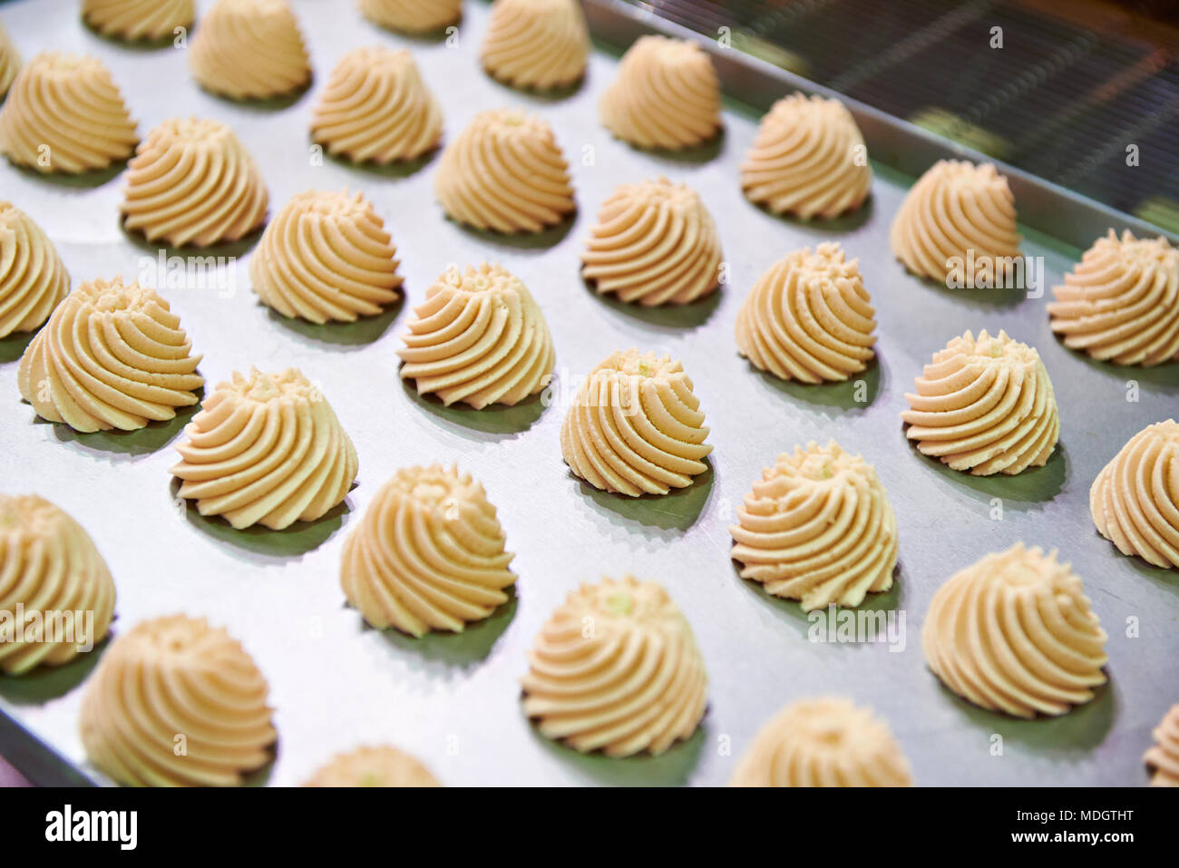 Confectionery products from cream on baking sheet Stock Photo - Alamy