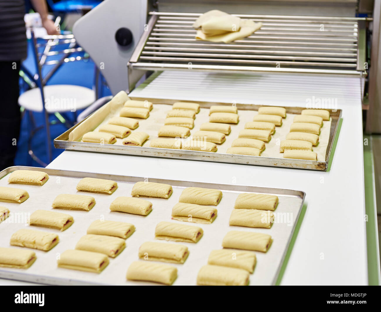Cake on baking trays of confectionery conveyor Stock Photo - Alamy