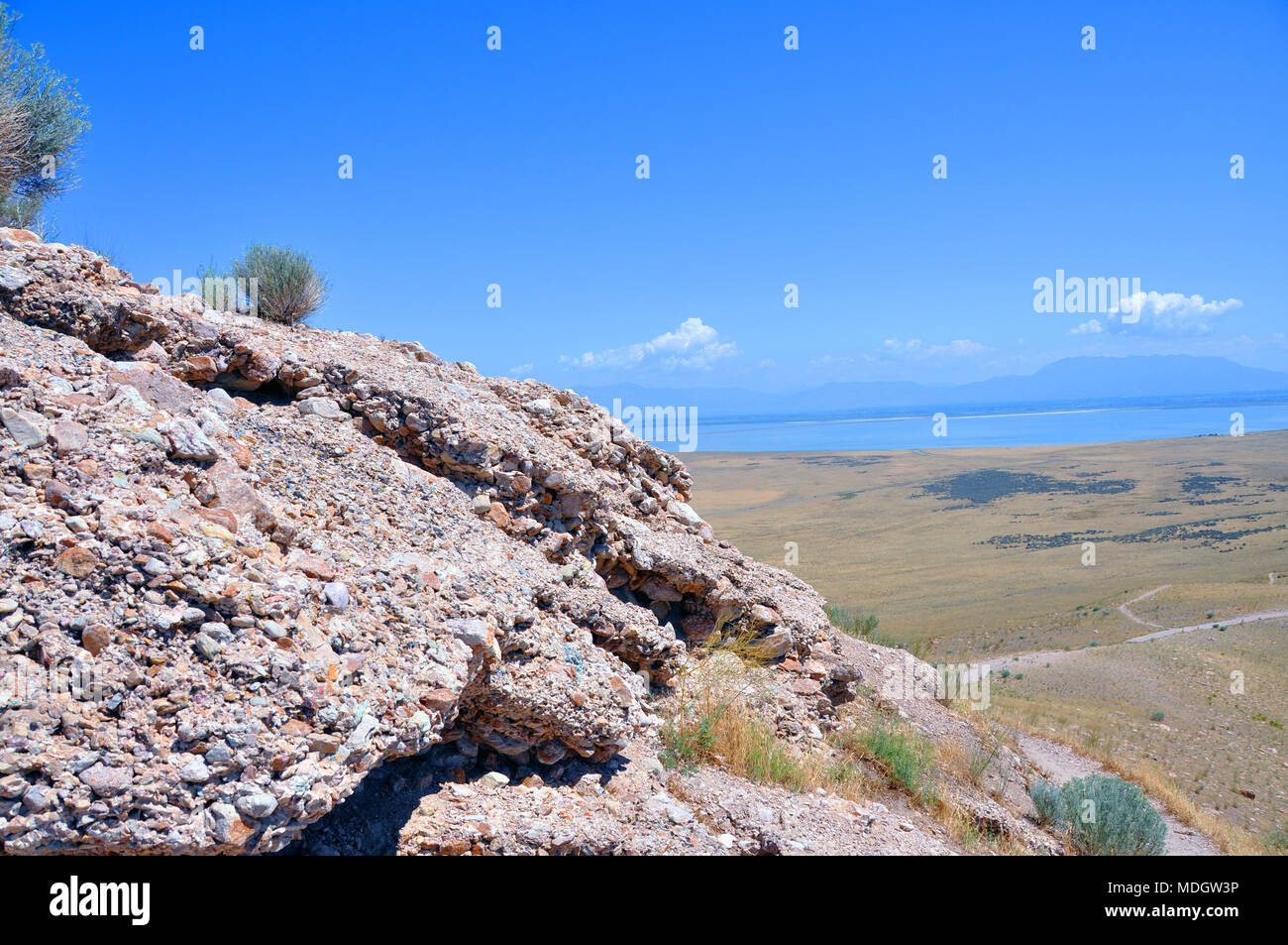Cliff overlooking field and lake Stock Photo - Alamy