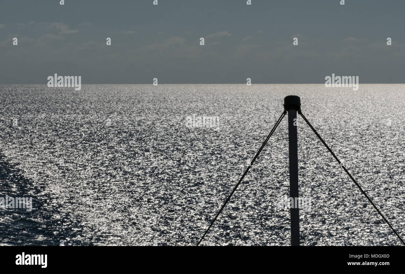 View of a glistening ocean from the back of a cruise ship in the late ...