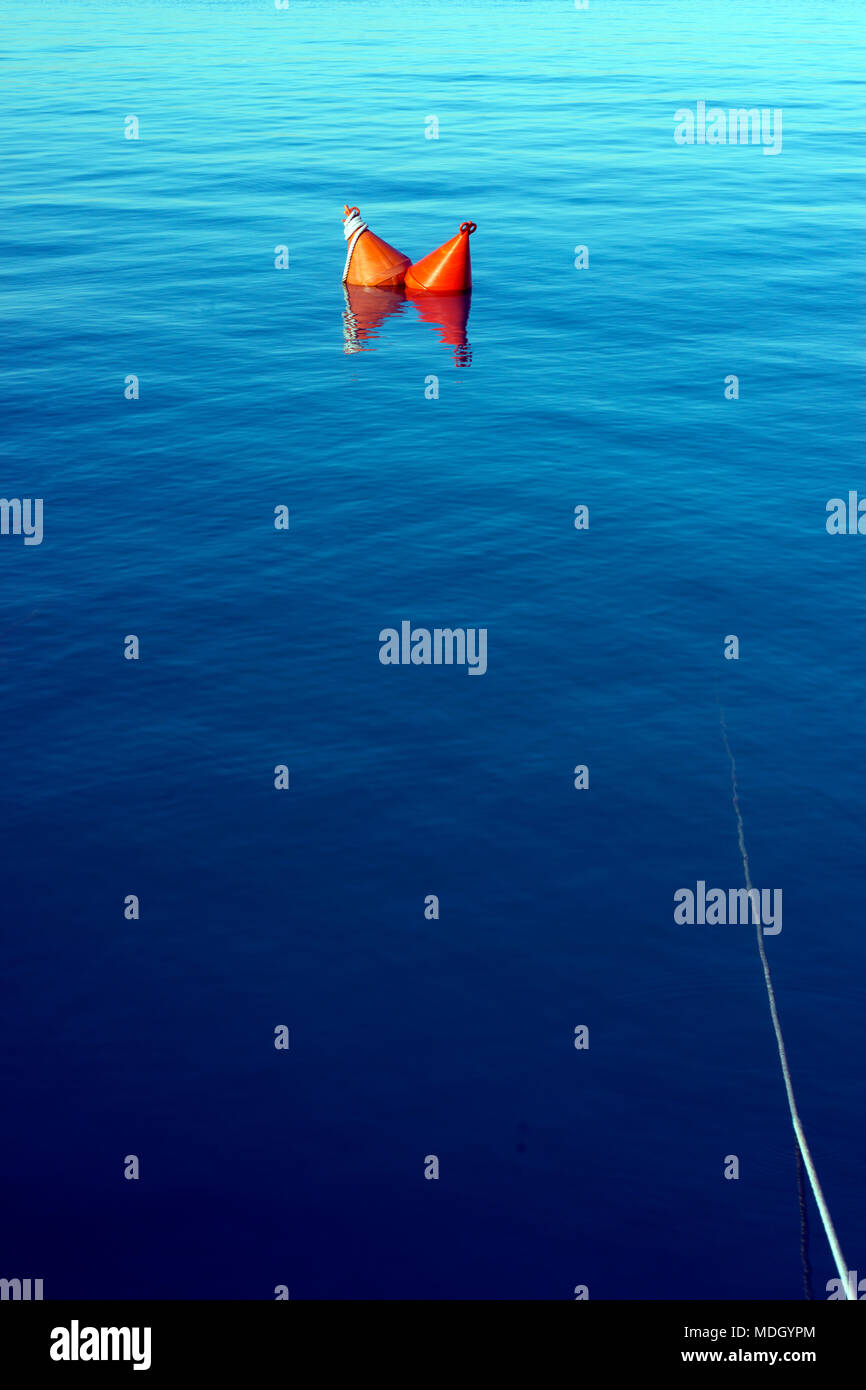 two joined red buoys in clear blue sea water Stock Photo - Alamy