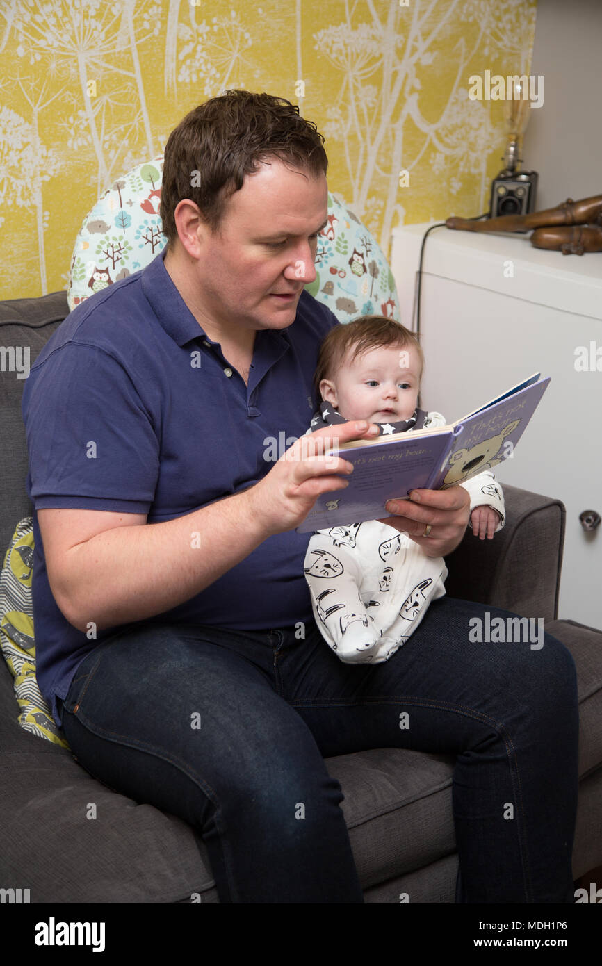 Father reading to baby Stock Photo - Alamy