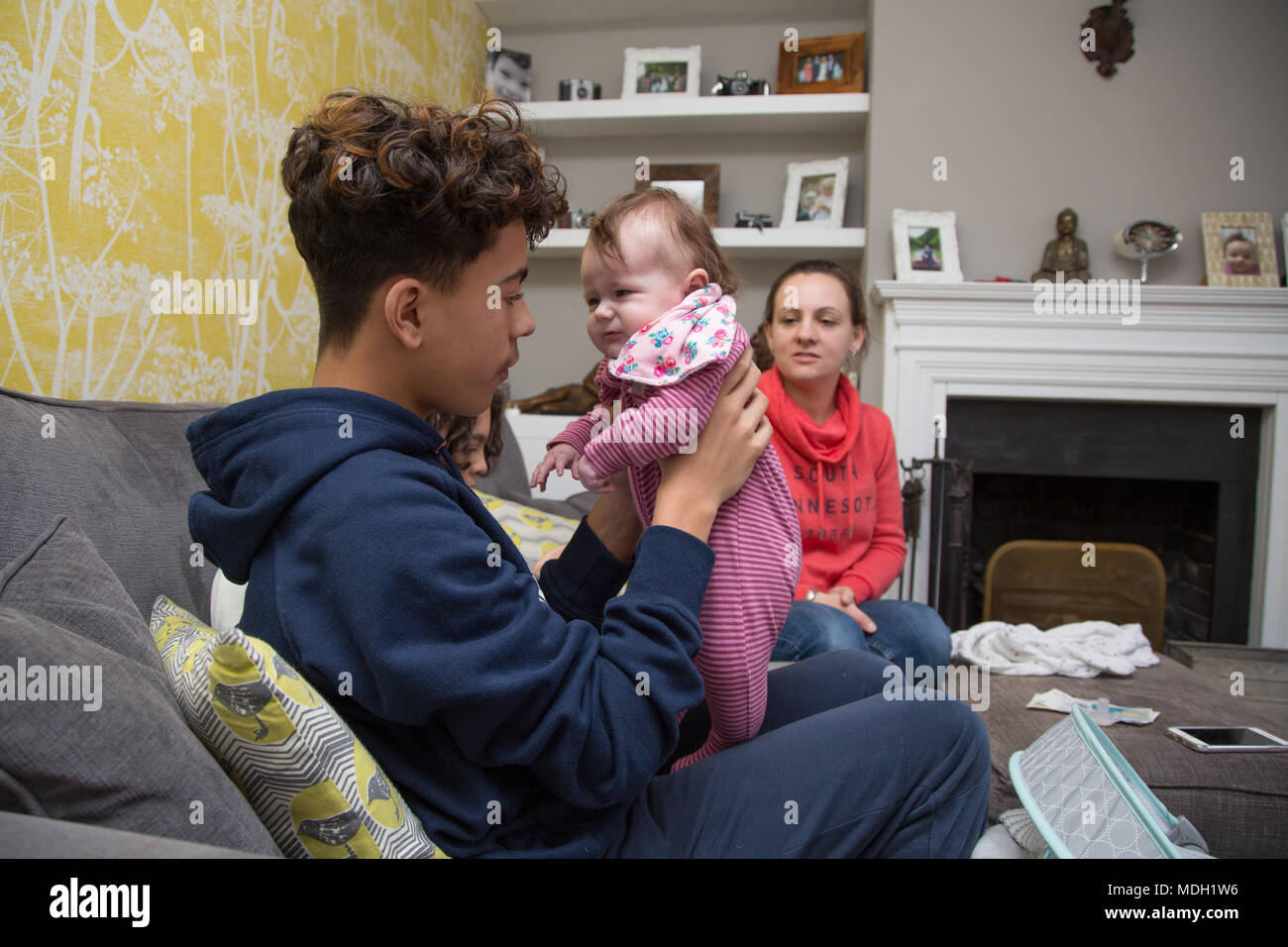 Young children babysitting Stock Photo - Alamy