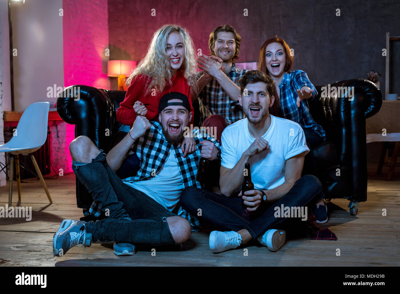 Cheerful college friends watching photos hi-res stock photography and ...