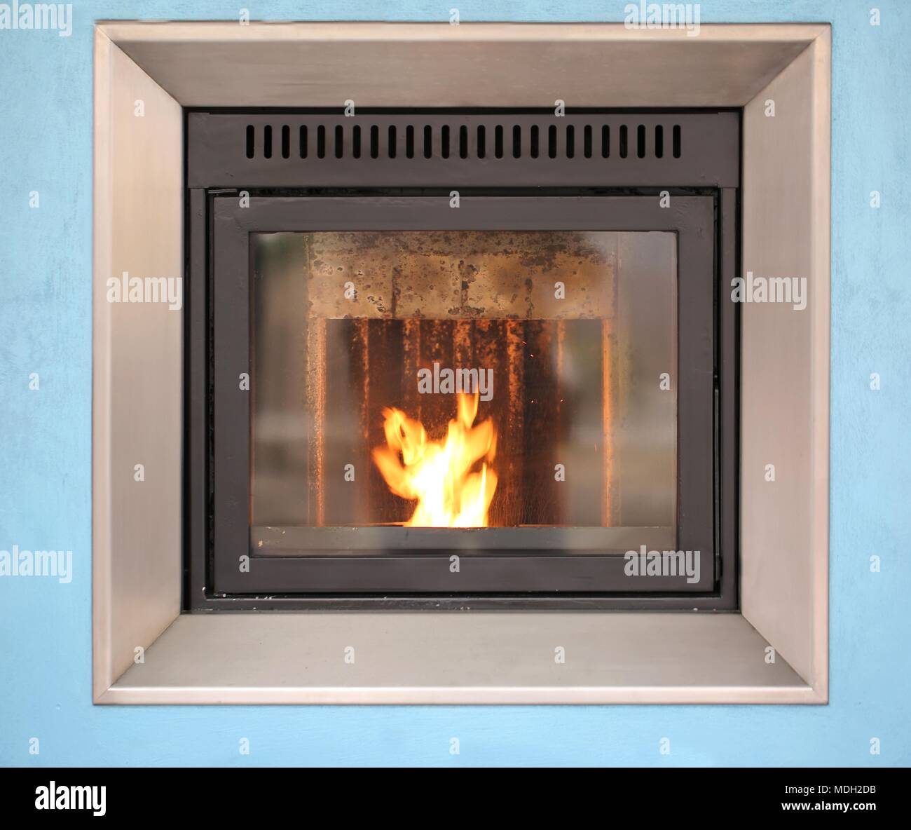 modern stove with a warm flame and protective glass Stock Photo - Alamy