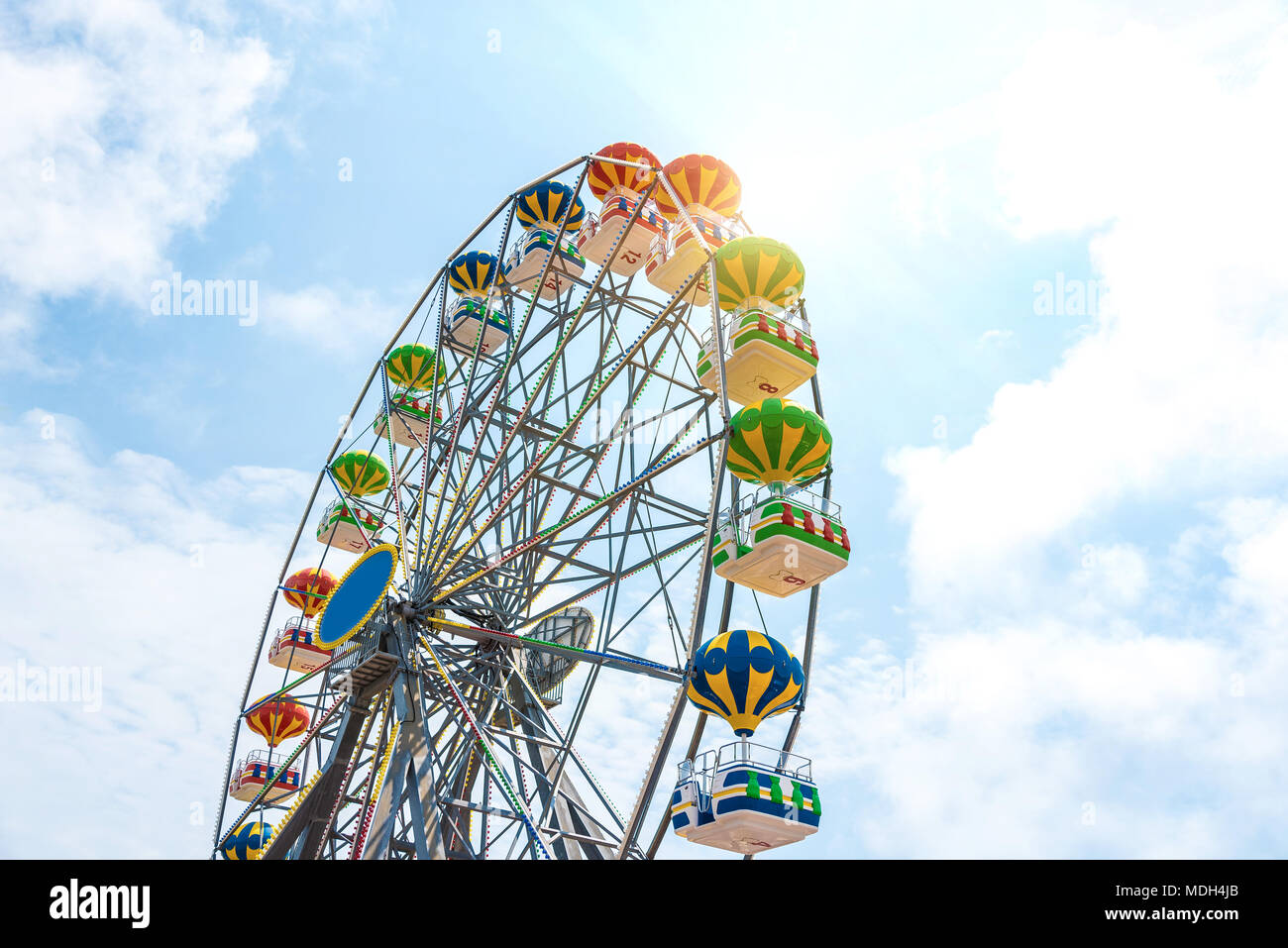 Colorful Ferris wheel against the blue sky Stock Photo - Alamy