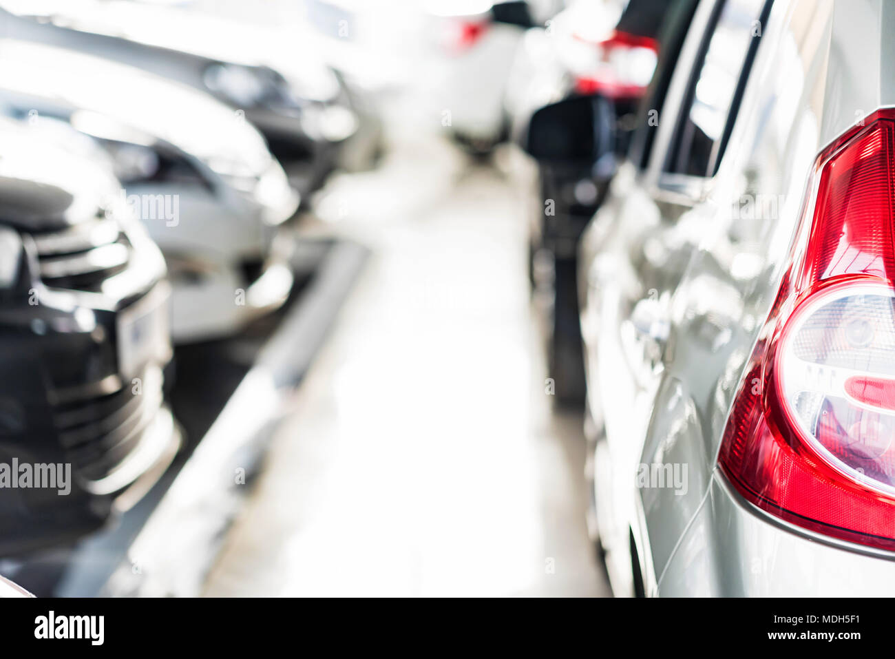 New cars at dealer showroom blurred background Stock Photo - Alamy