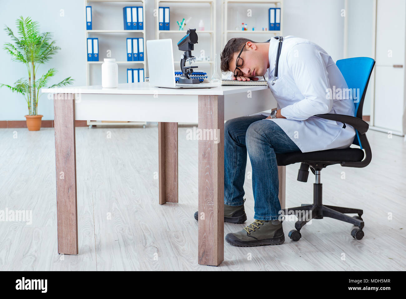 Tired doctor at computer night hi-res stock photography and images - Alamy