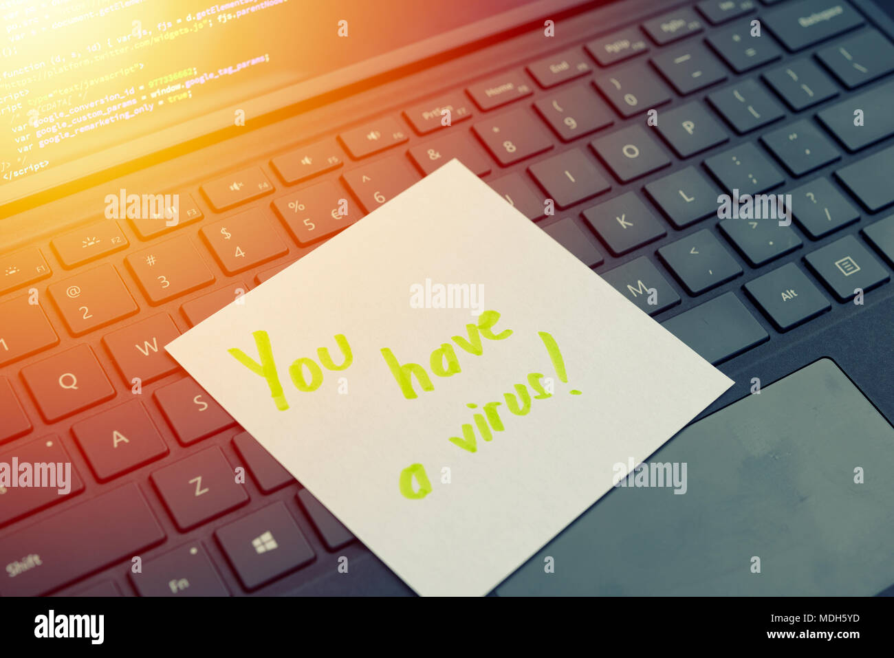 You have a virus message concept written post it on laptop keyboard ...