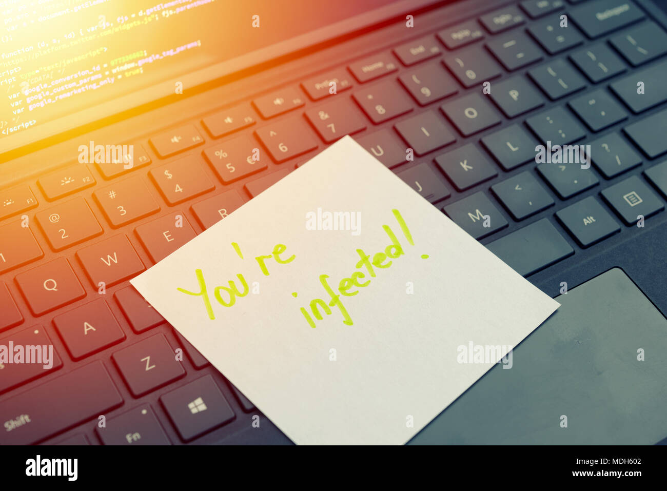 You're infected message concept written post it on laptop keyboard ...