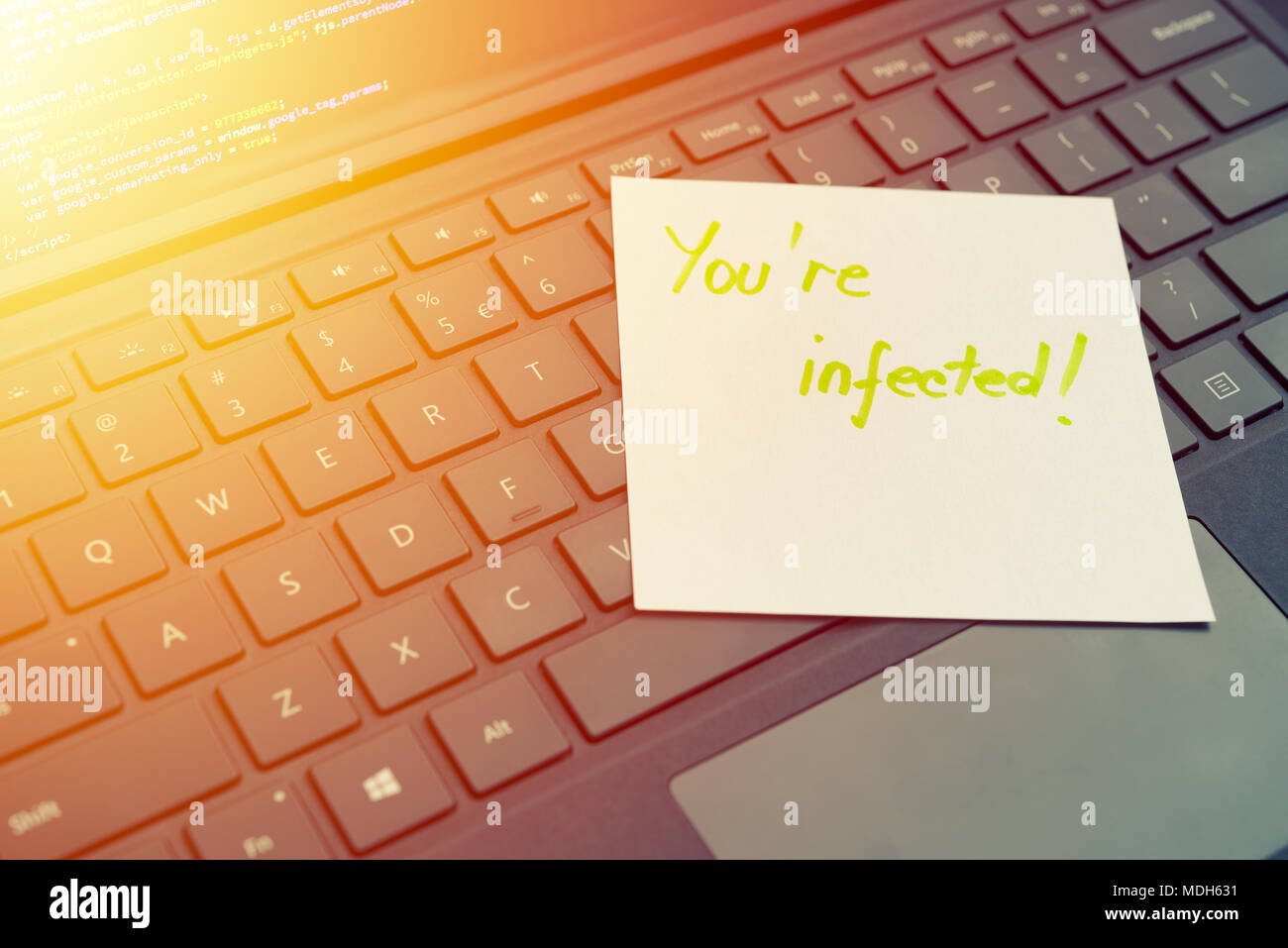 You're infected message concept written post it on laptop keyboard ...