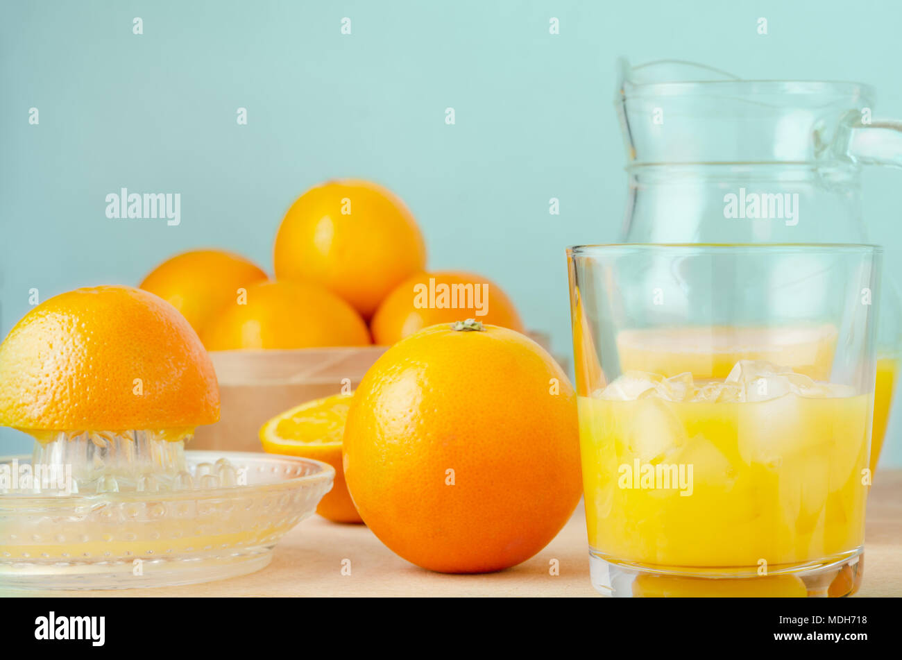 Manual juice squeezing process with whole and cut oranges, squeezer ...