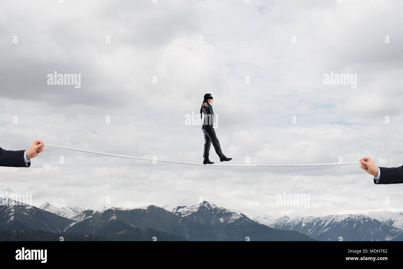 Business concept of risk support and assistance with man balancing on ...