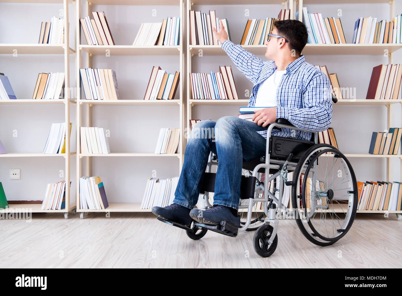 Disabled student studying in the library Stock Photo - Alamy