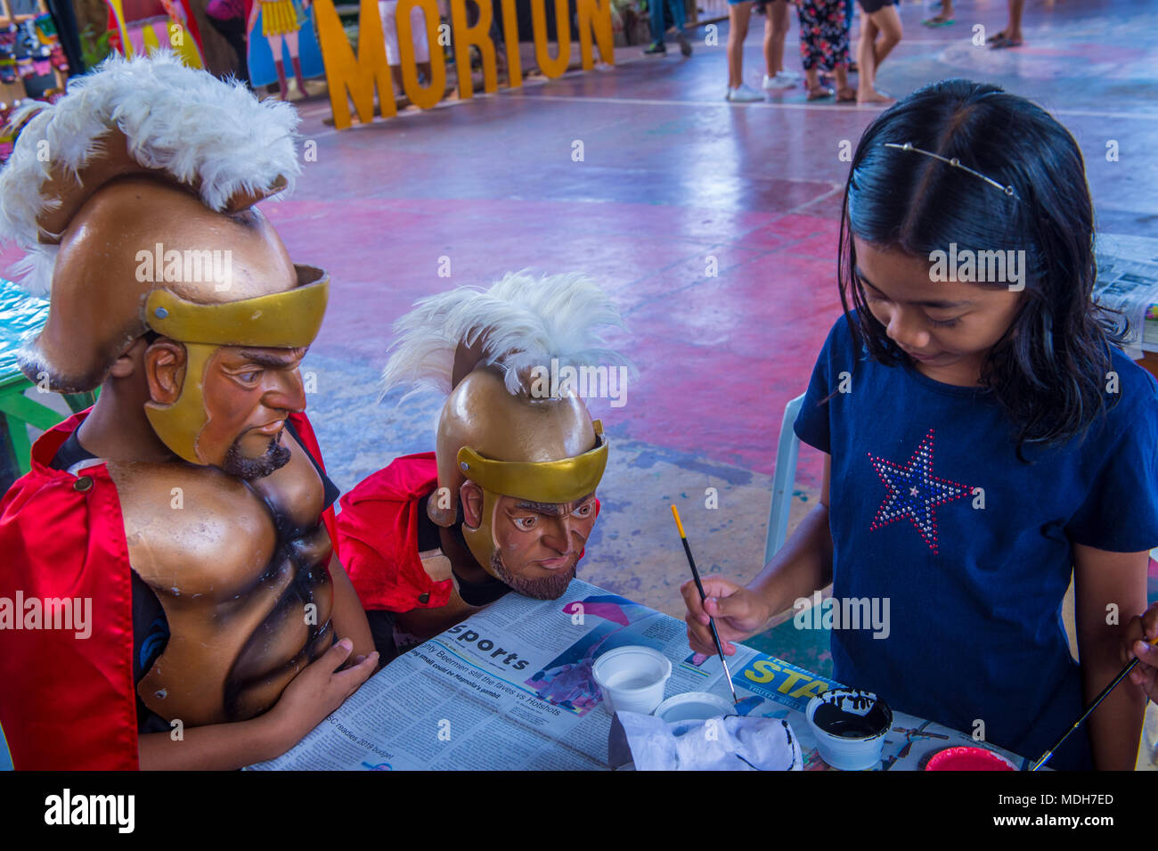 children decorating masks during the Moriones festival in Boac ...